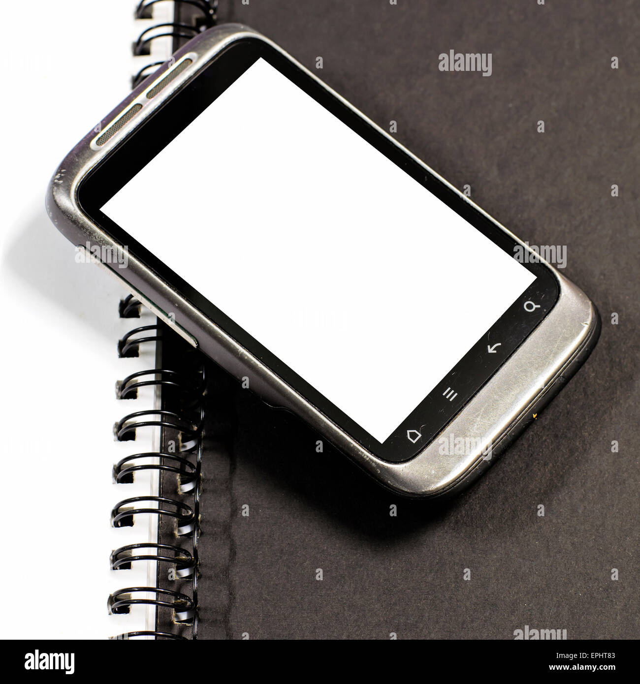 smartphone on note book on a white background Stock Photo - Alamy