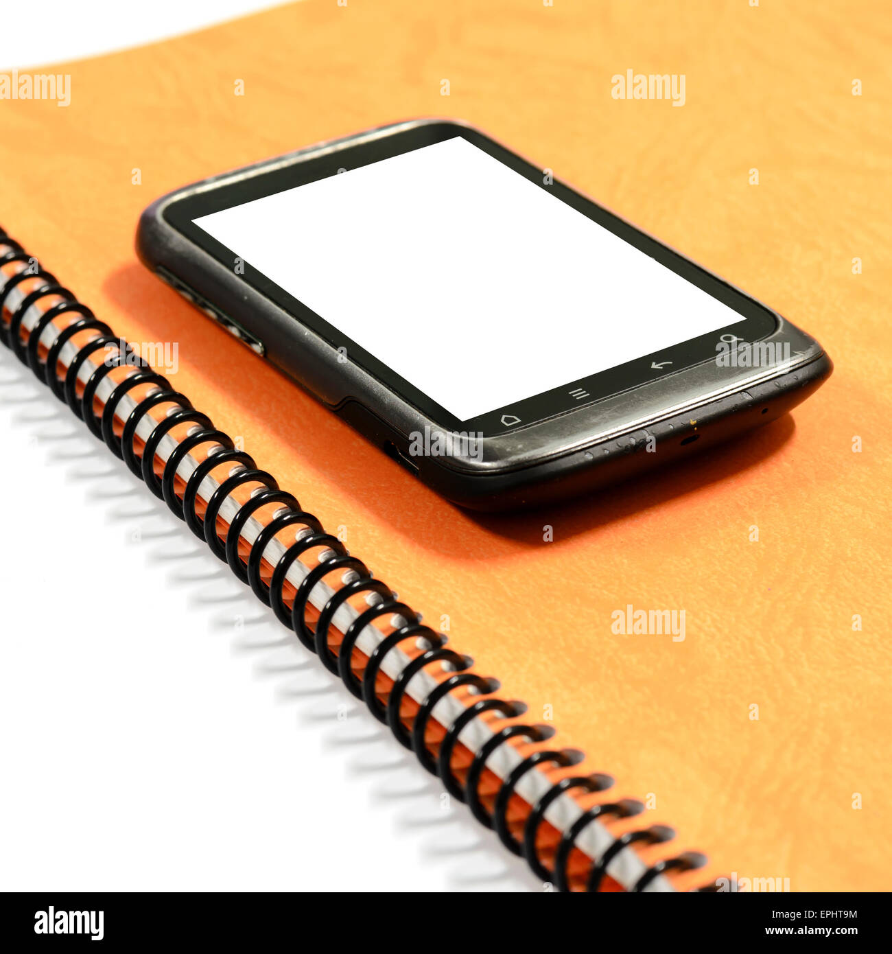 smartphone with orange note book on a white background Stock Photo - Alamy