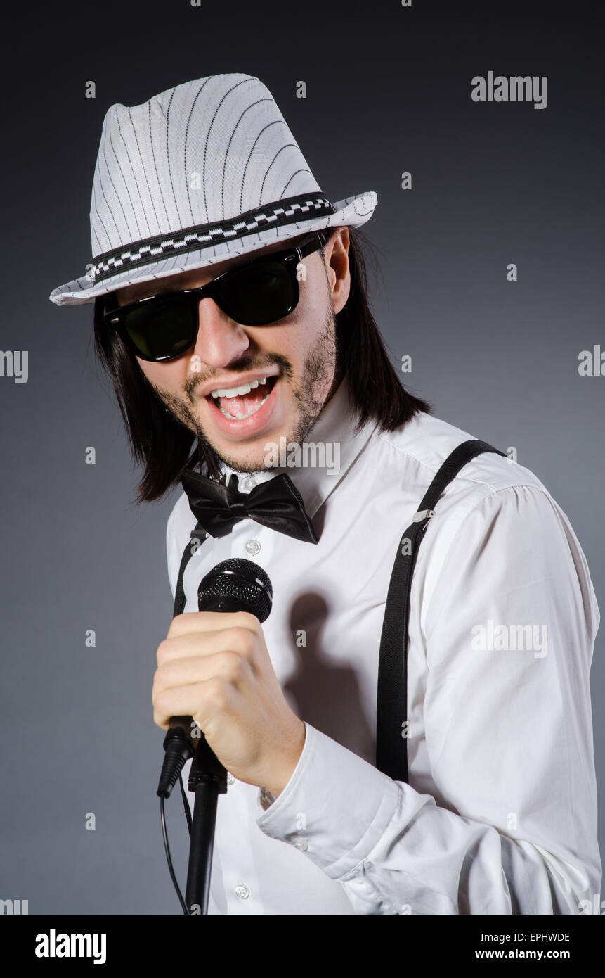 Funny singer with microphone at the concert Stock Photo - Alamy