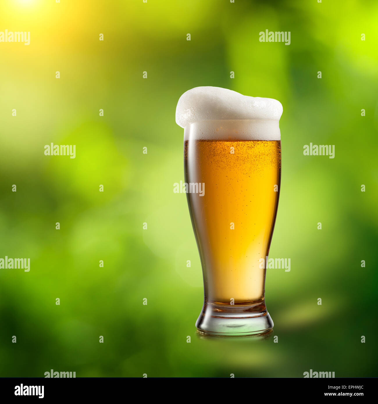 Beer in glass on natural background Stock Photo - Alamy