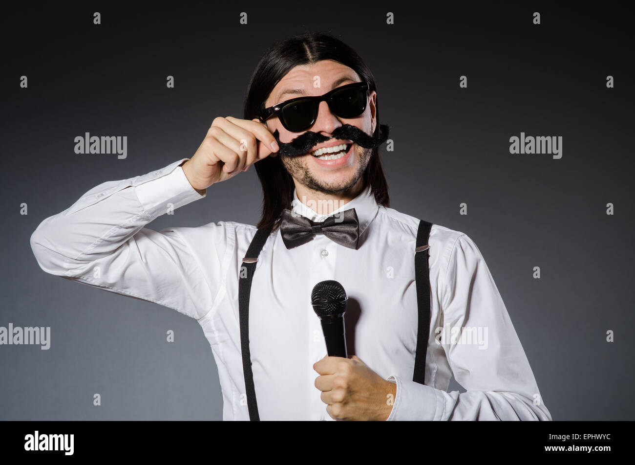 Funny singer with microphone at the concert Stock Photo - Alamy