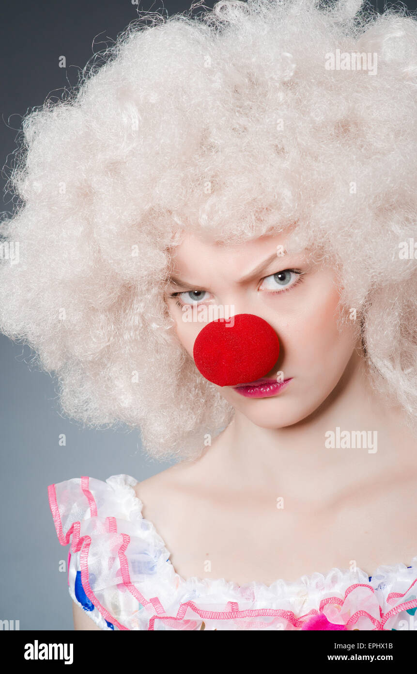 Clown with white wig against grey background Stock Photo - Alamy