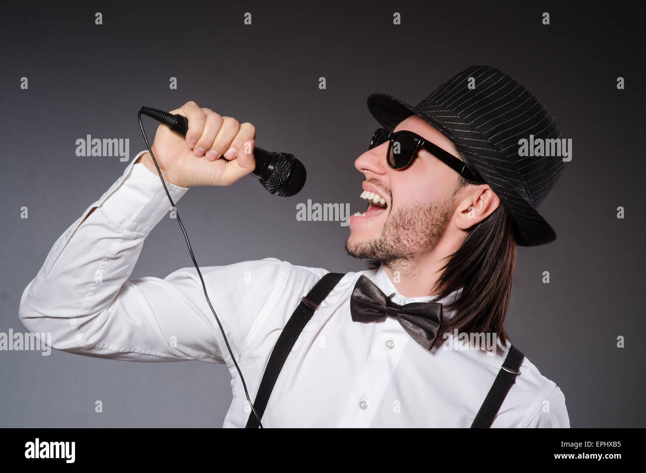 Funny singer with microphone at the concert Stock Photo - Alamy