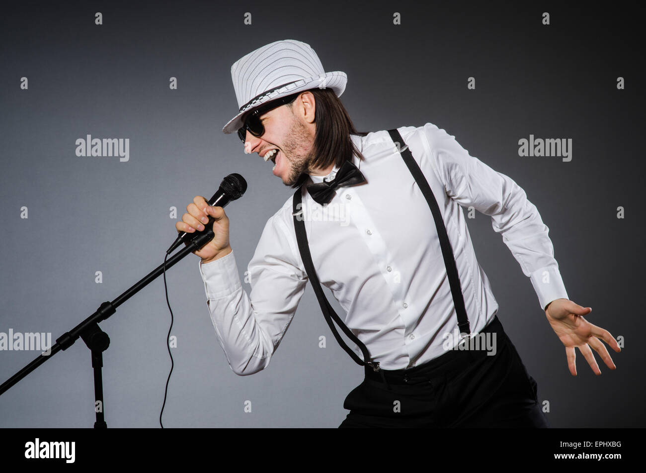 Funny singer with microphone at the concert Stock Photo - Alamy