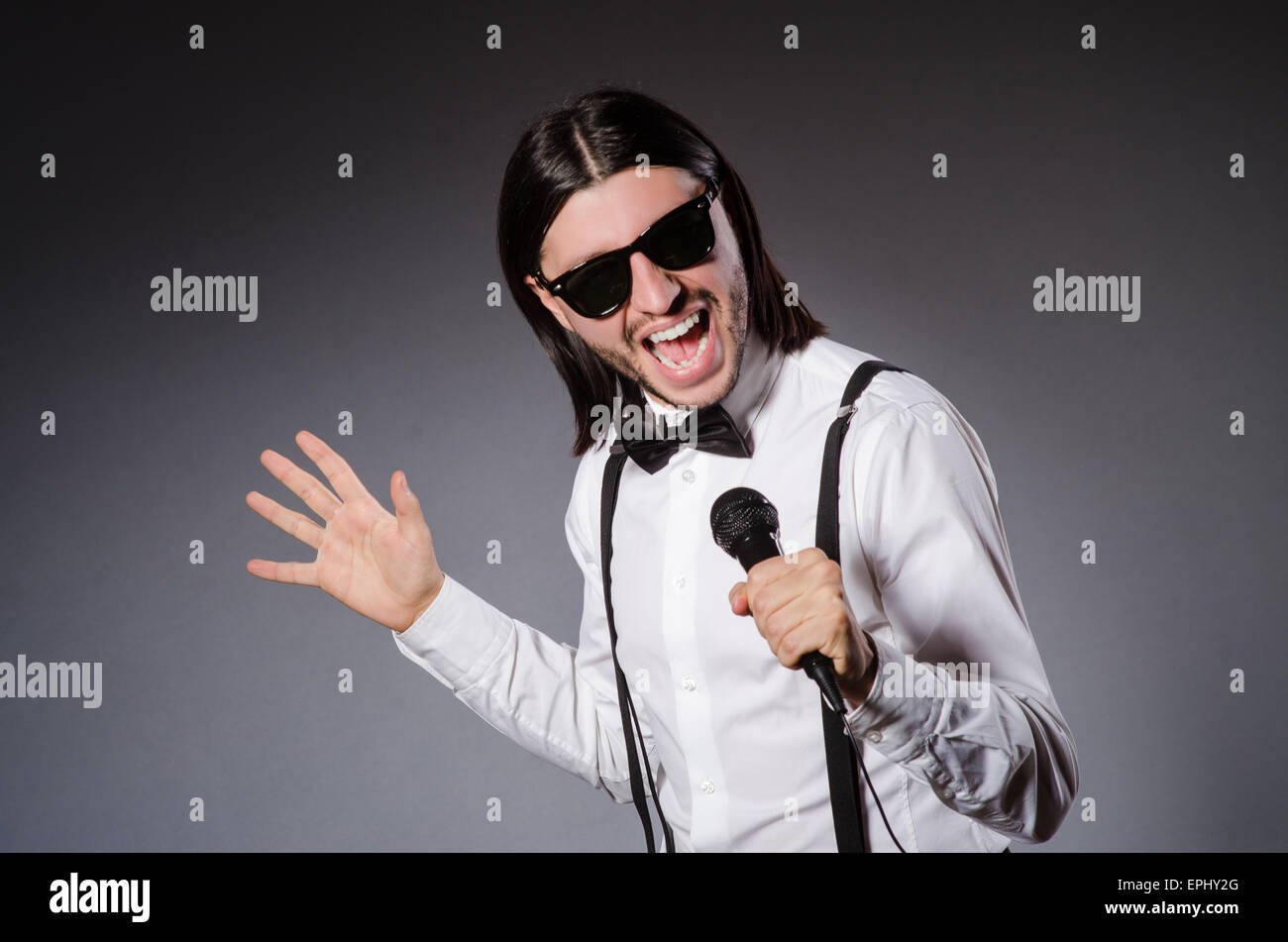 Funny singer with microphone at the concert Stock Photo - Alamy