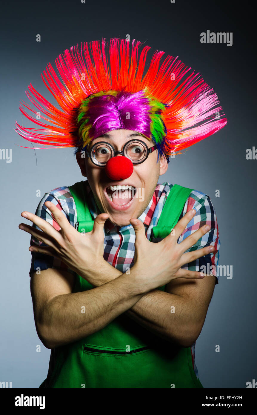 Funny clown against the grey background Stock Photo - Alamy