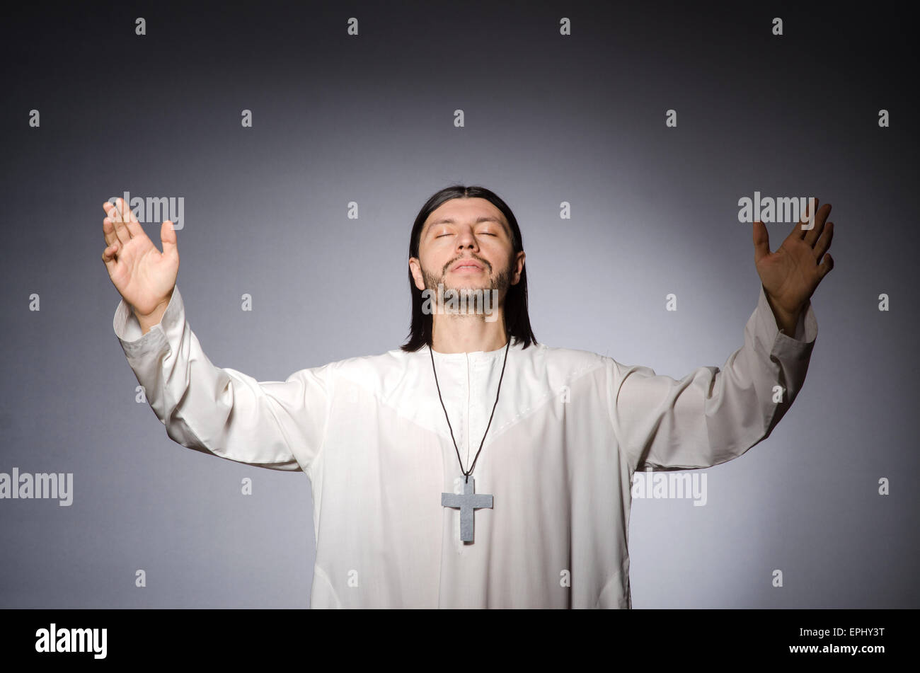 Priest cross robe religion church holy man black hi-res stock ...