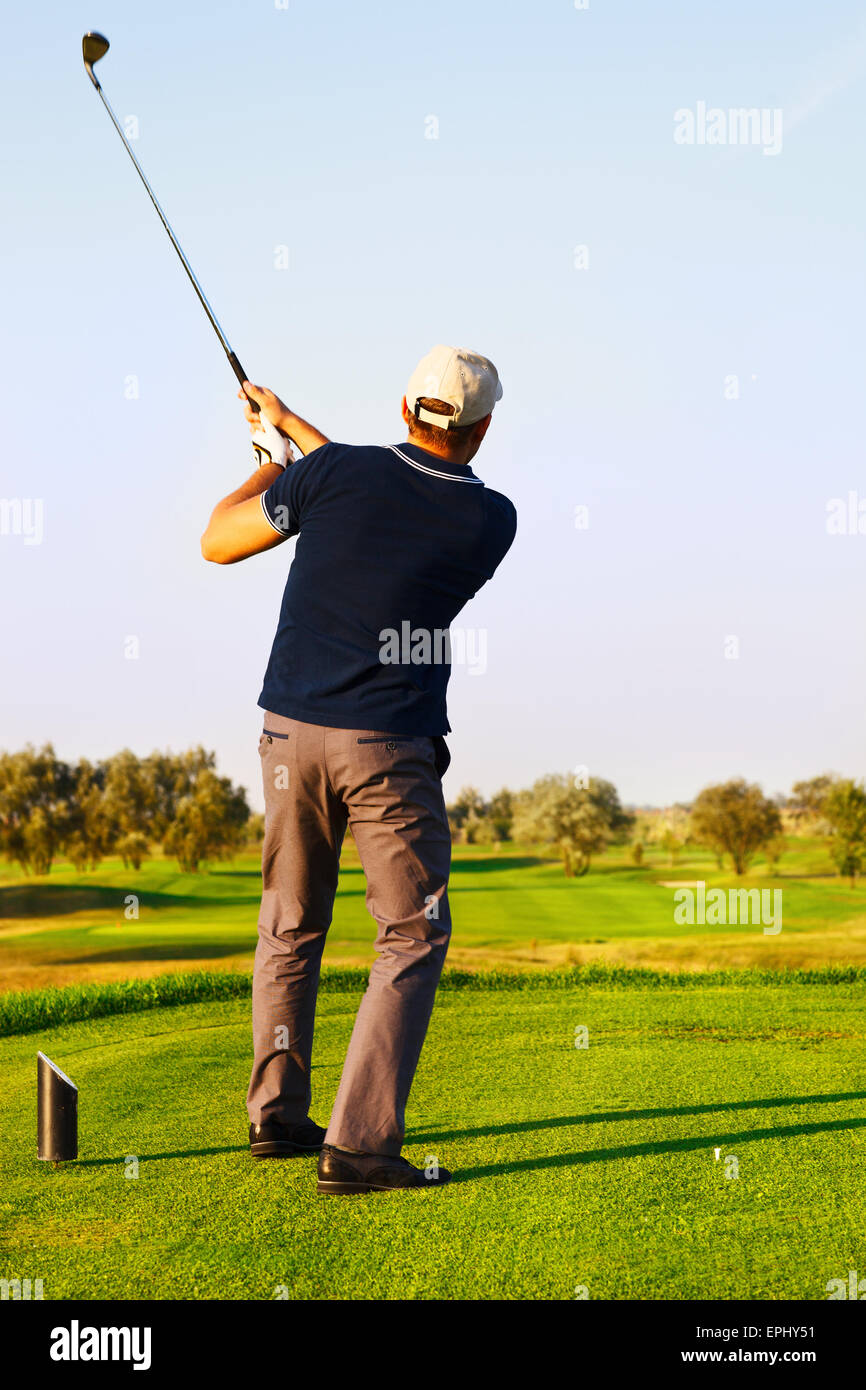 Athletic young man playing golf Stock Photo - Alamy