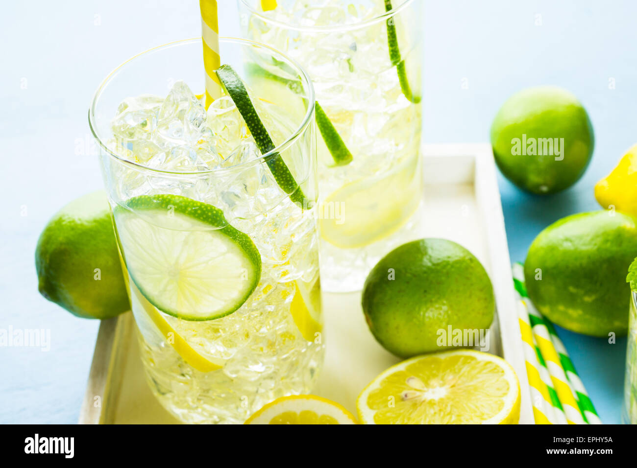 Infused water with fresh citrus fruits and ice Stock Photo - Alamy