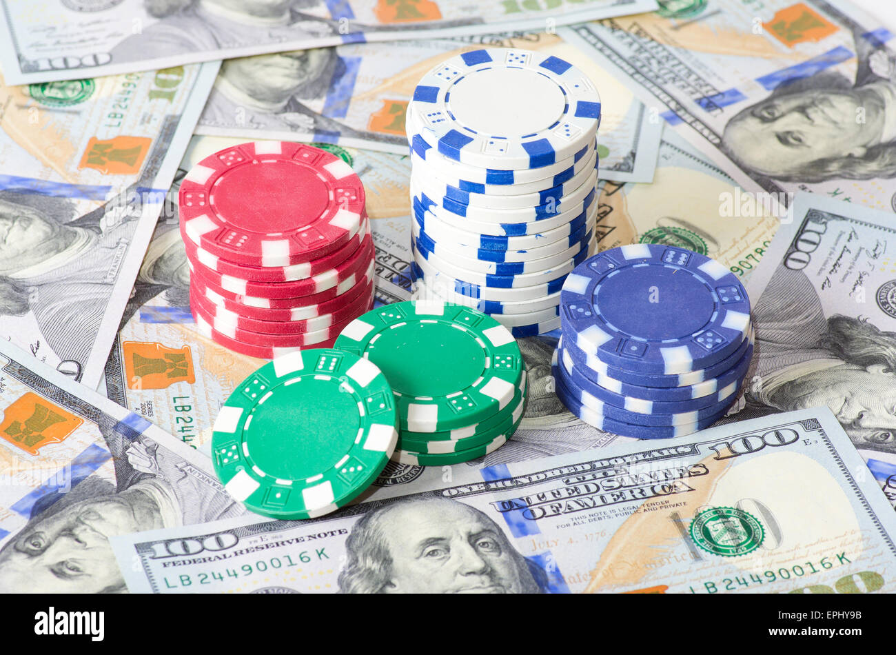 Gambling chips and heap of dollars Stock Photo - Alamy