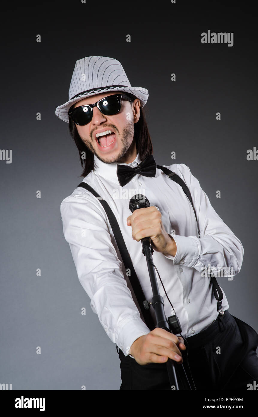 Funny singer with microphone at the concert Stock Photo - Alamy
