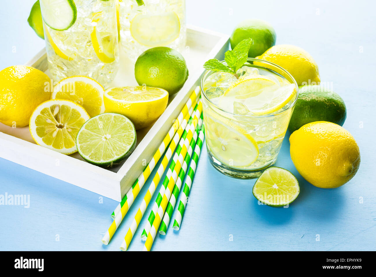 Infused water with fresh citrus fruits and ice Stock Photo - Alamy