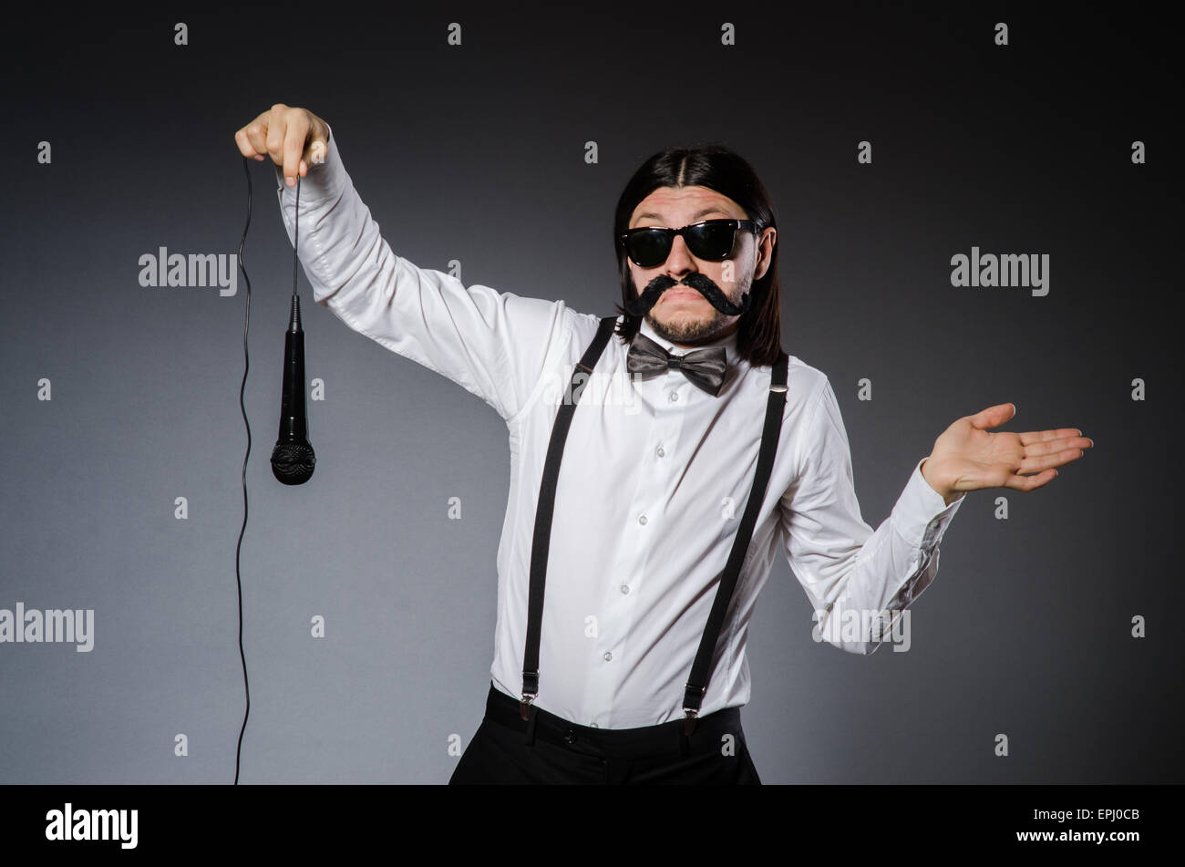Funny singer with microphone at the concert Stock Photo - Alamy