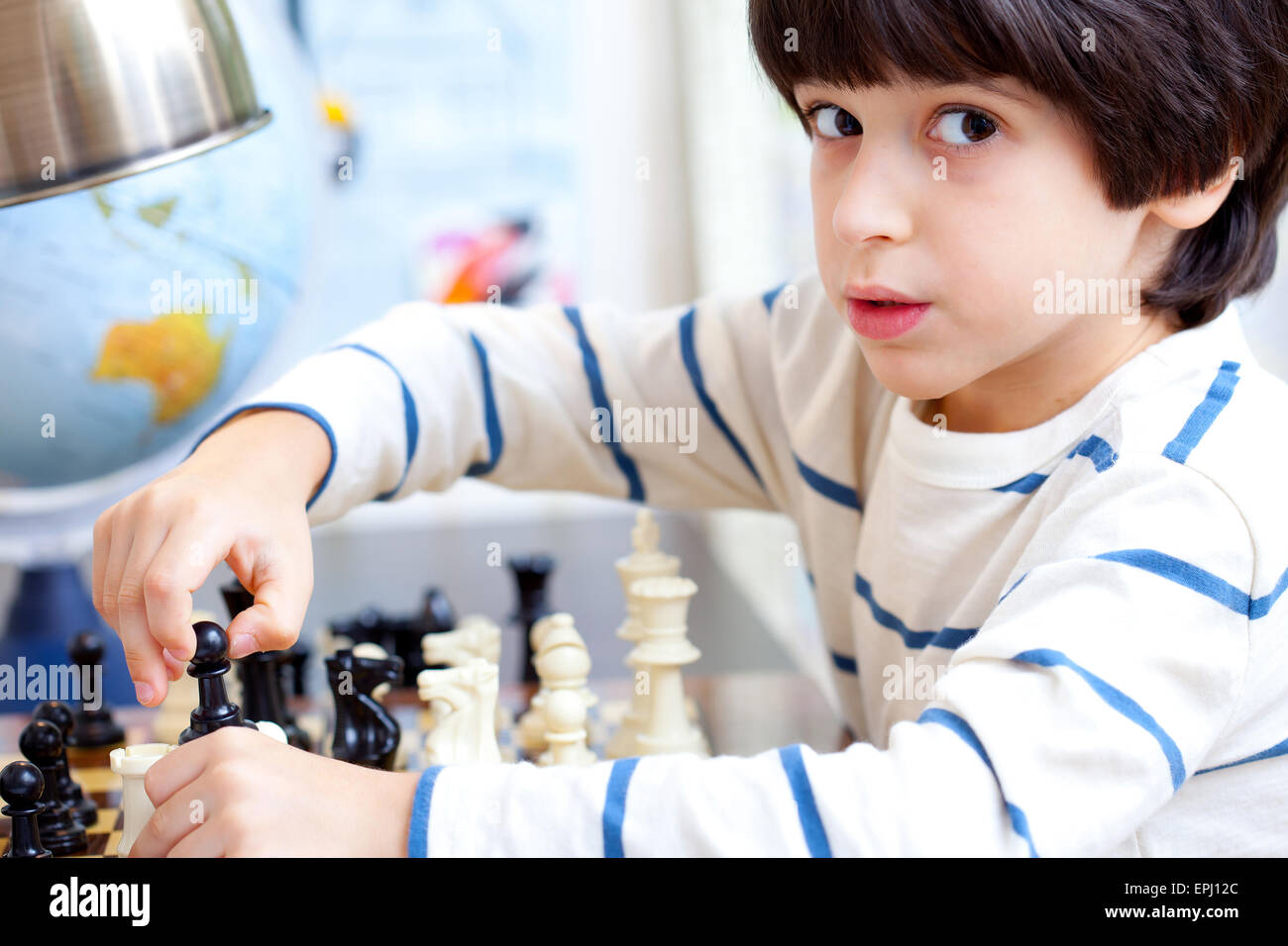 boy playing a game of chess Stock Photo - Alamy