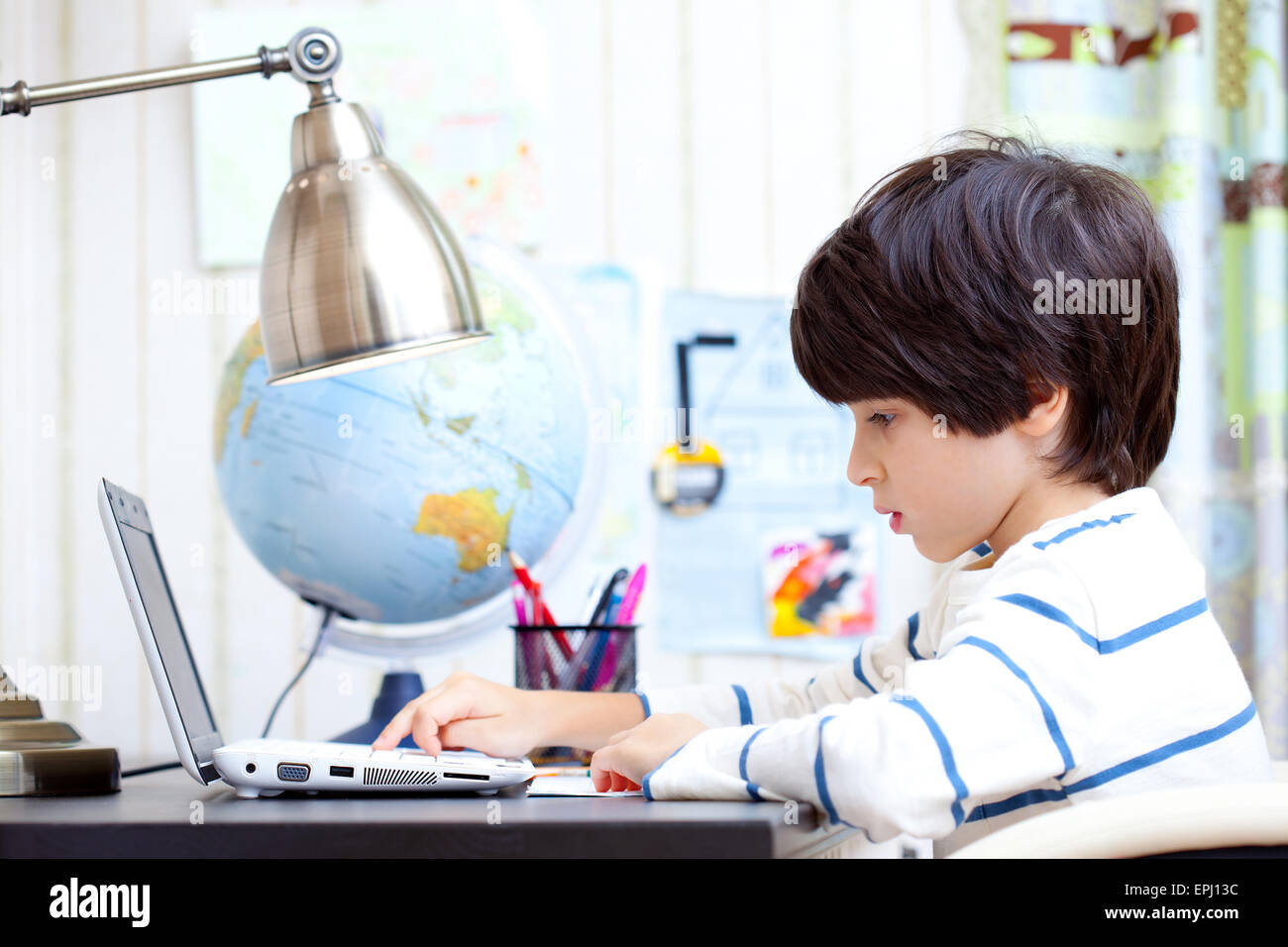 schoolboy working on a computer Stock Photo - Alamy