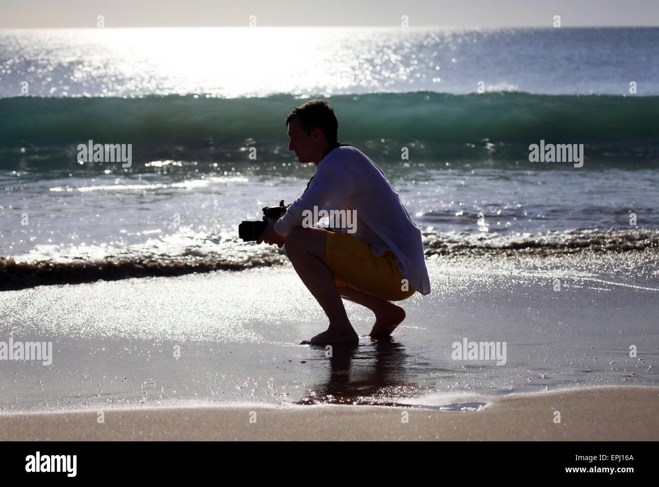 Photographer on a beach Stock Photo - Alamy