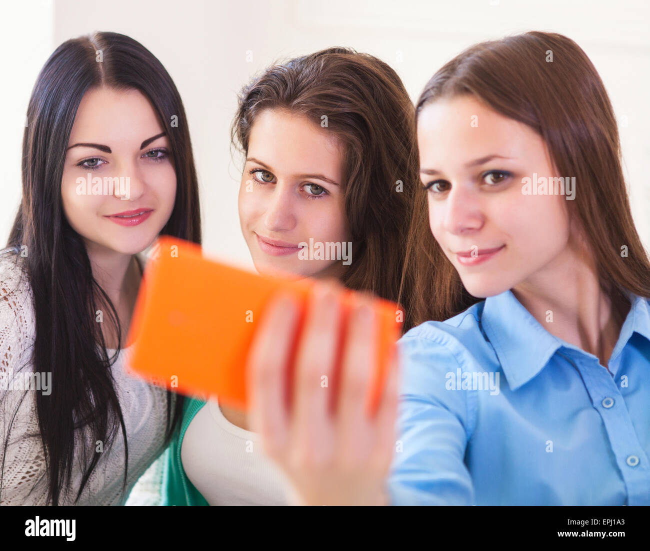 Three Smiling Teenage Girls Taking Selfie With Smartphone Camera Stock