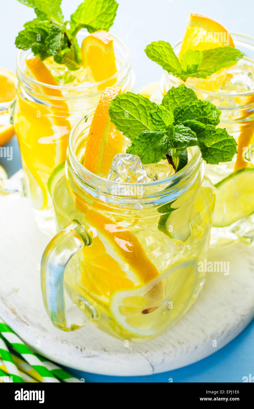 Infused water with fresh citrus fruits and ice Stock Photo - Alamy