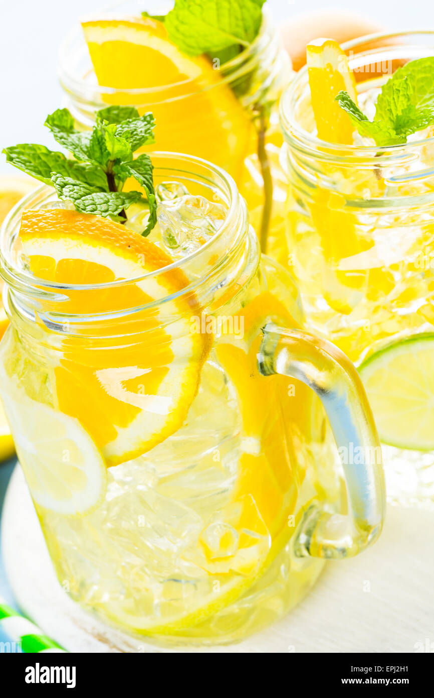 Infused water with fresh citrus fruits and ice Stock Photo - Alamy