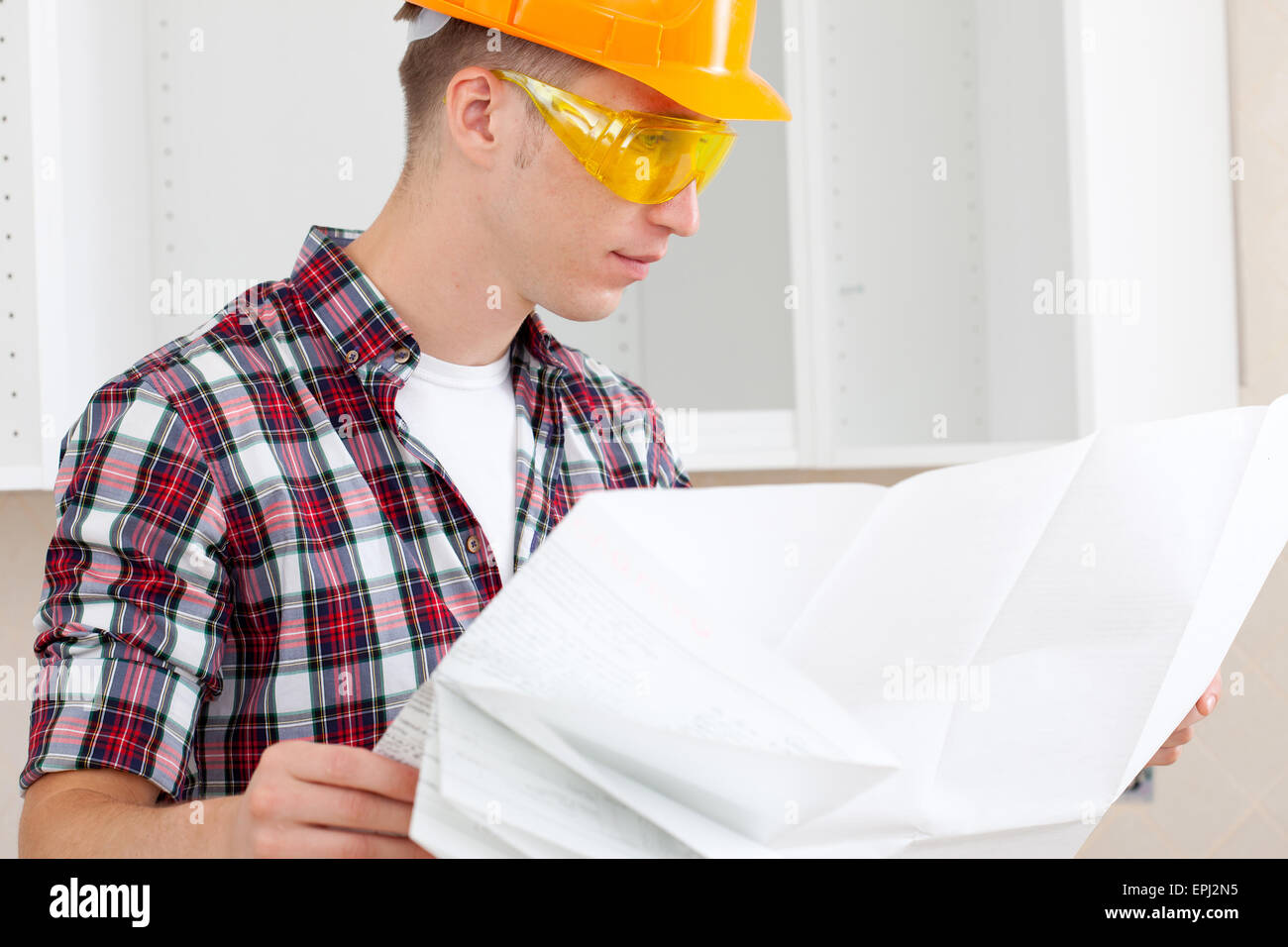 builder with repair plan Stock Photo - Alamy