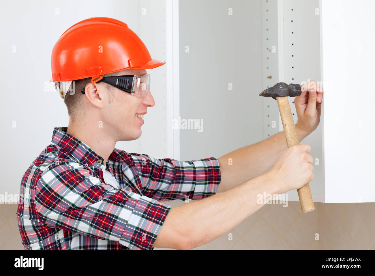 worker with a hammer Stock Photo - Alamy