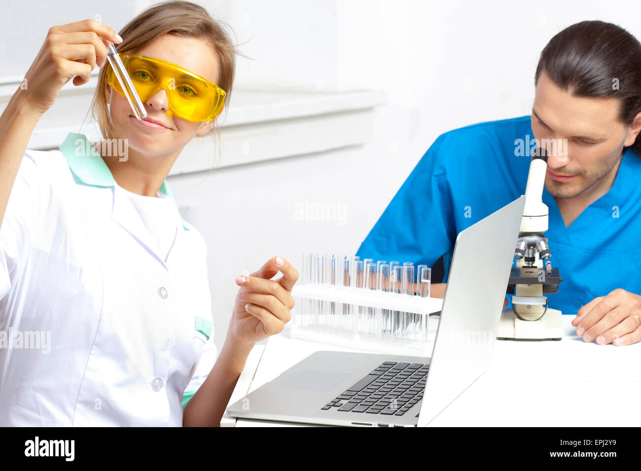 Doctor examines a test tube Stock Photo - Alamy