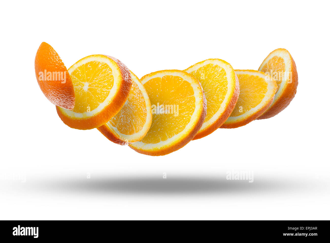 Falling slices of orange in air on white Stock Photo - Alamy