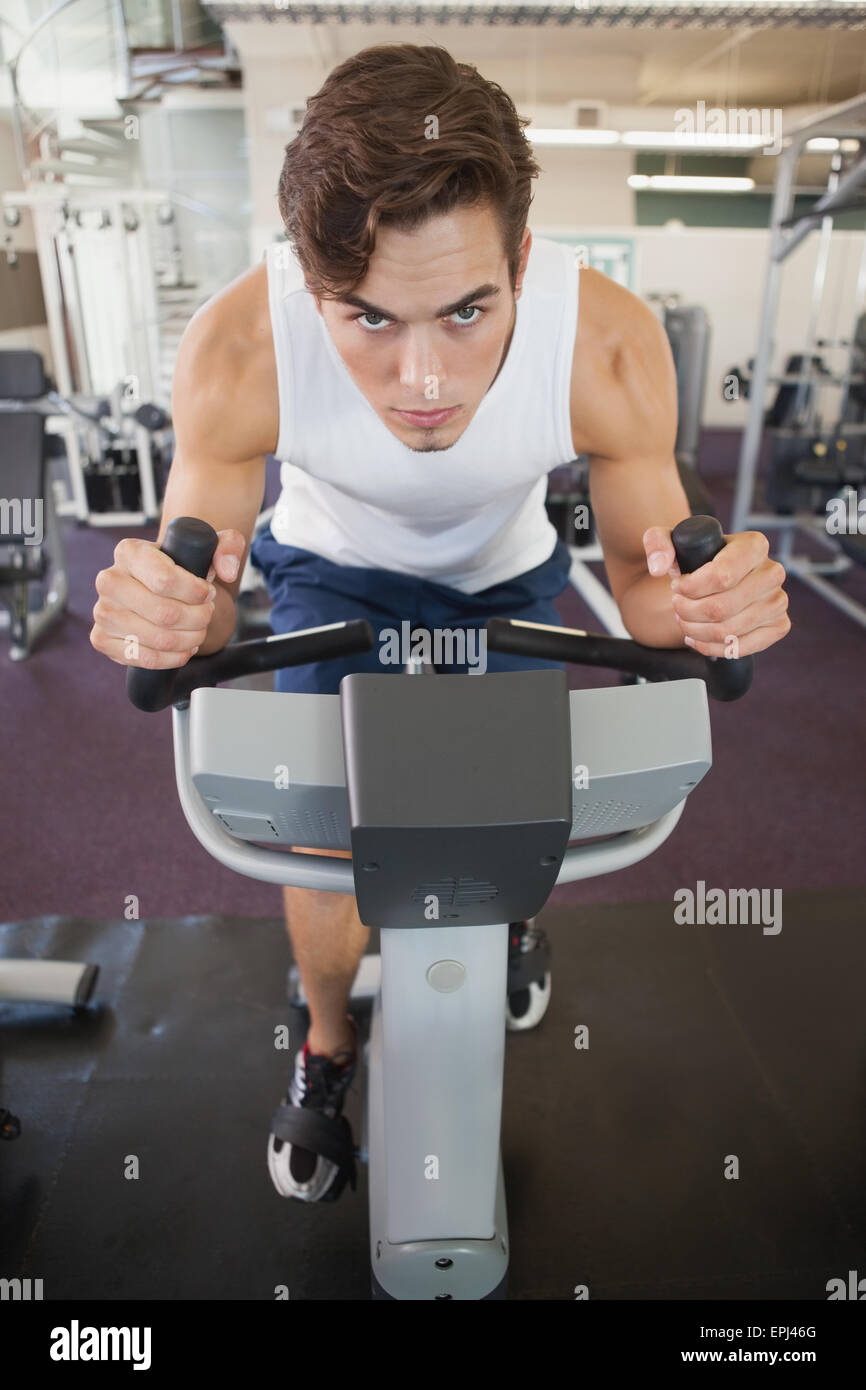 Fit man working out on the exercise bike Stock Photo - Alamy