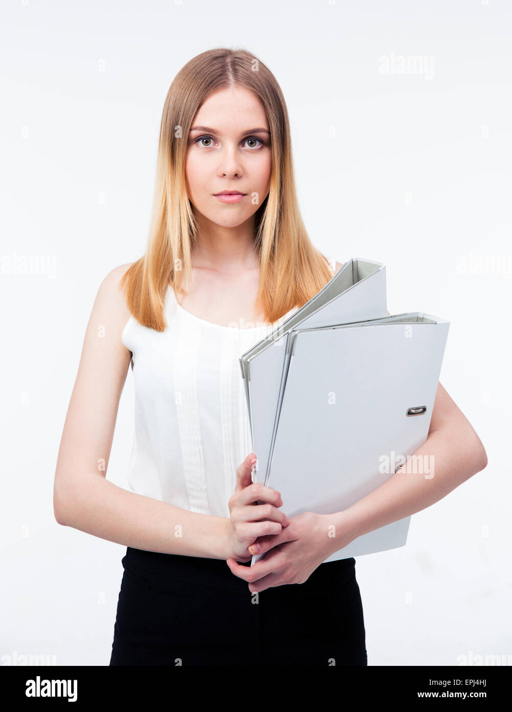 Serious young business woman holding folders over gray background and ... Serious young business woman holding folders over gray background and ...