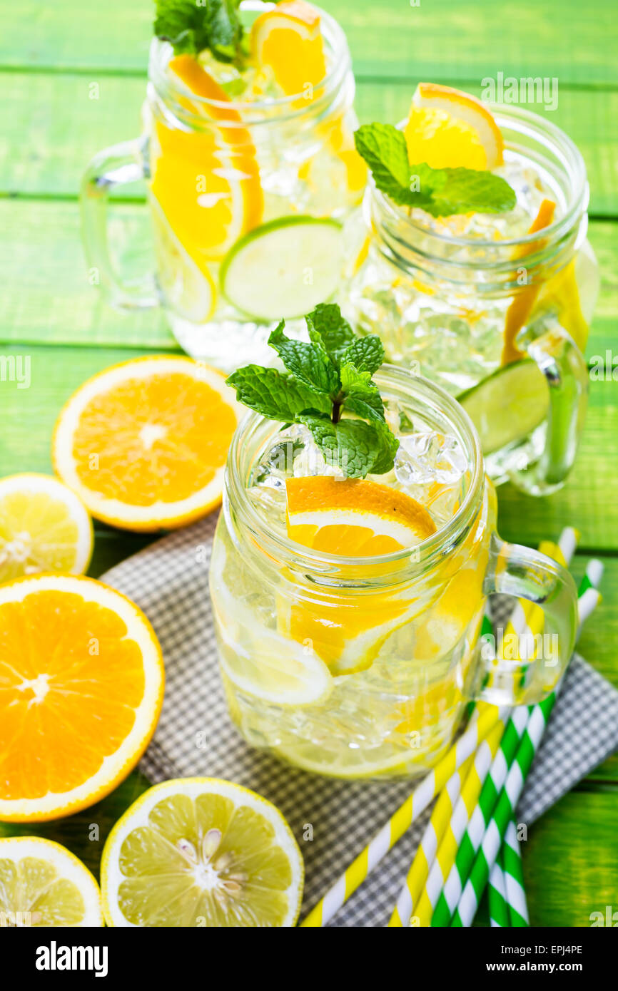 Infused water with fresh citrus fruits and ice Stock Photo - Alamy