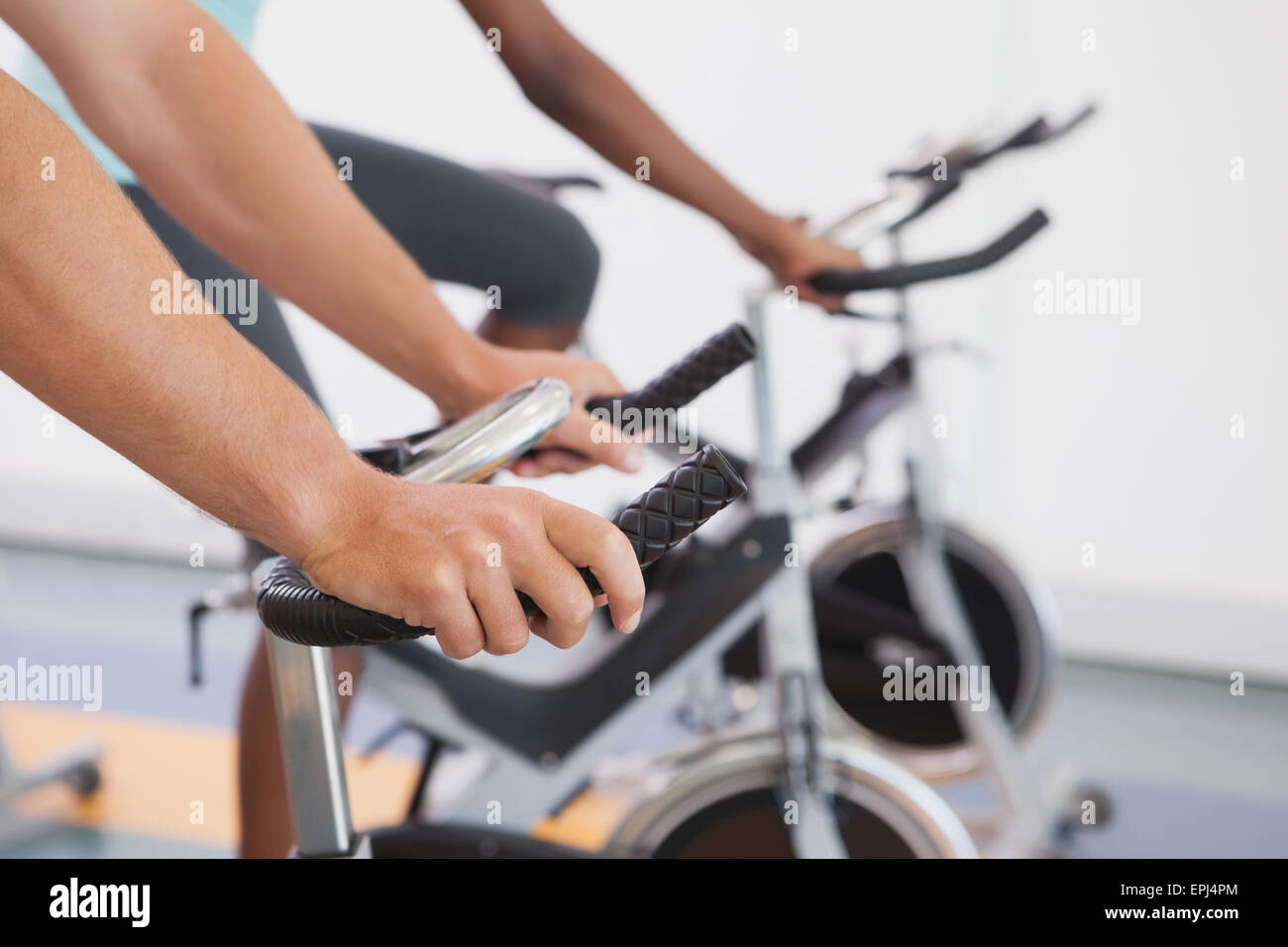 Fit people working out on the exercise bikes Stock Photo - Alamy