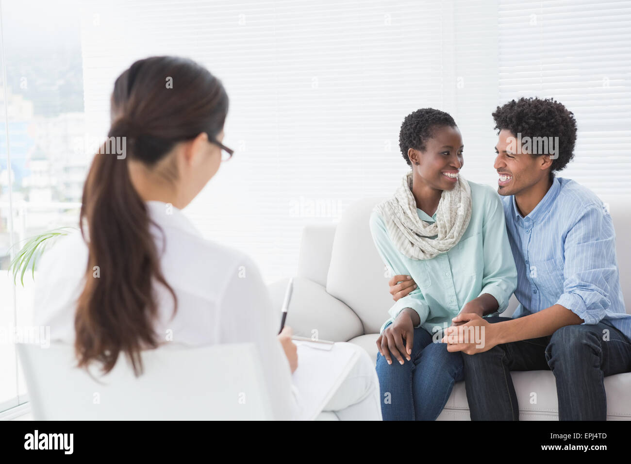 Reconciled couple smiling at each other Stock Photo - Alamy