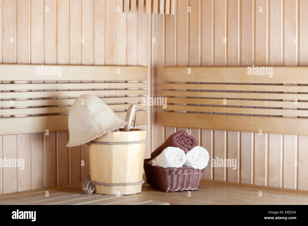 Traditional wooden sauna for relaxation with bucket of water and set of ...