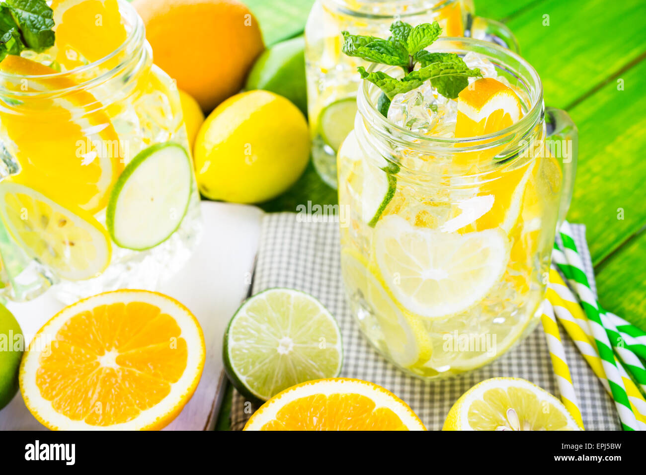 Infused water with fresh citrus fruits and ice Stock Photo - Alamy