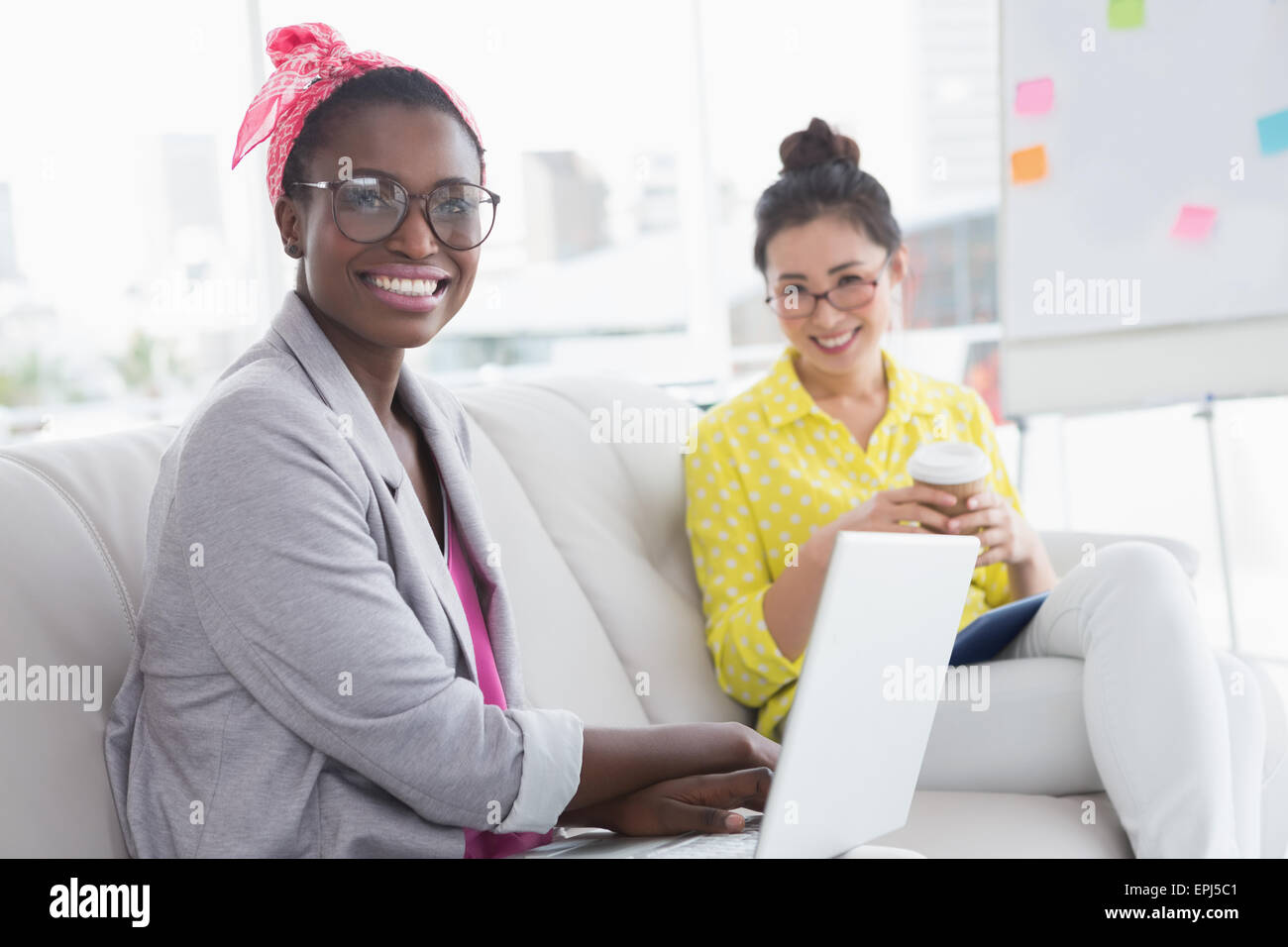 Young creative women on the couch Stock Photo - Alamy