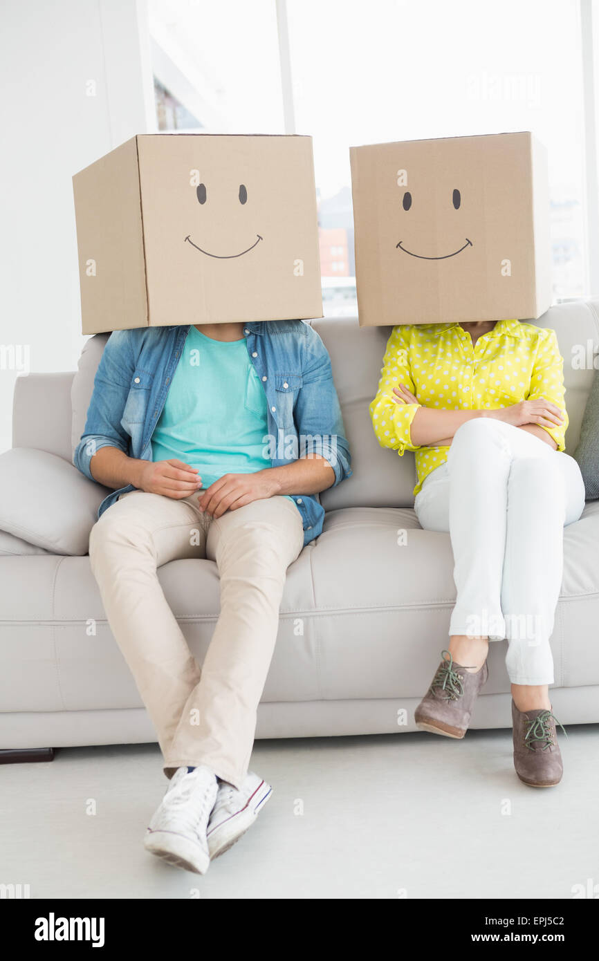 Young creative team wearing boxes on head Stock Photo - Alamy