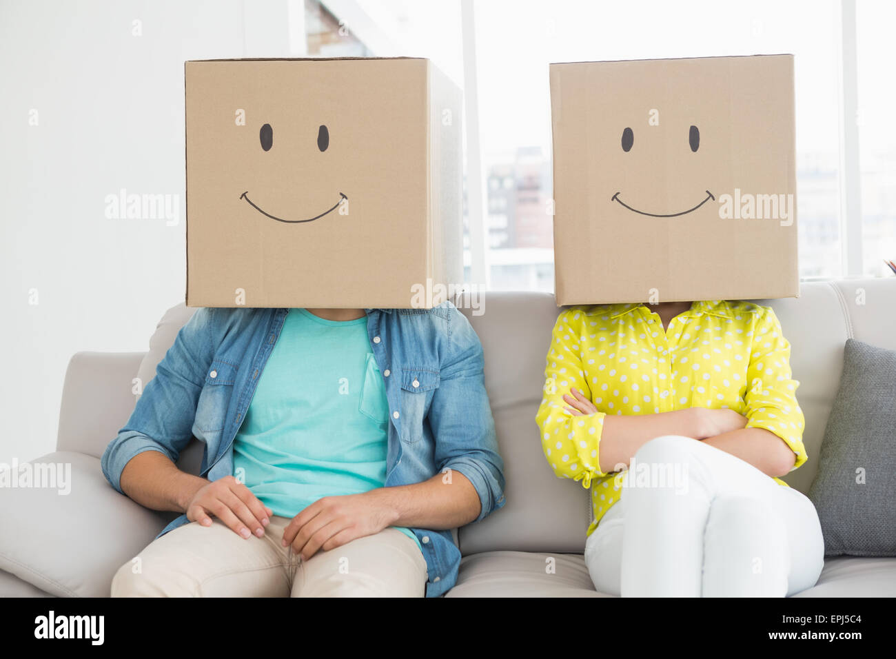 Young creative team wearing boxes on head Stock Photo - Alamy