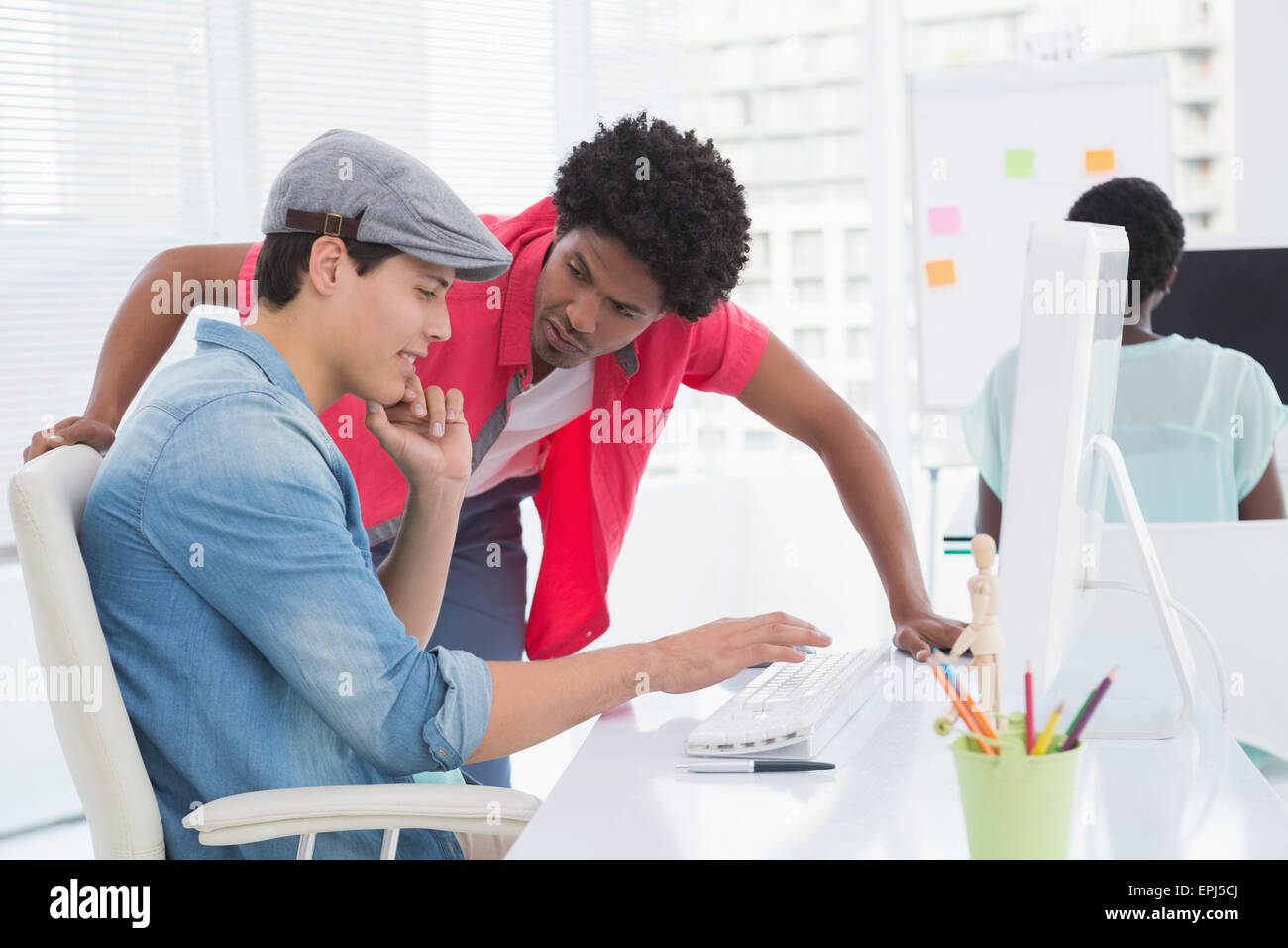 Young creative man working at desk Stock Photo - Alamy