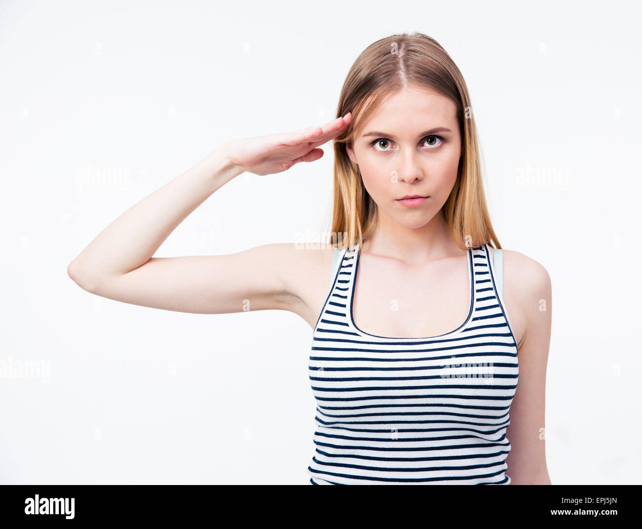 Portrait of a young cute woman saluting over gray background and ...