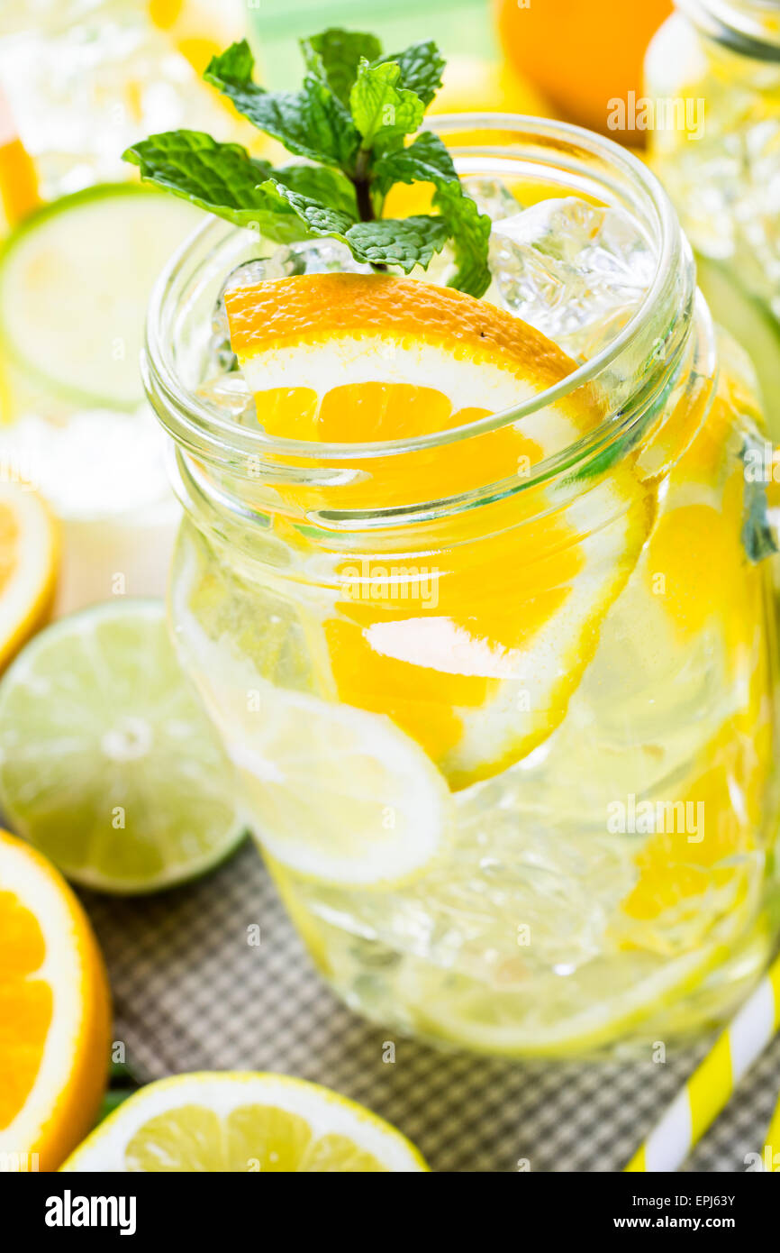 Infused water with fresh citrus fruits and ice Stock Photo - Alamy