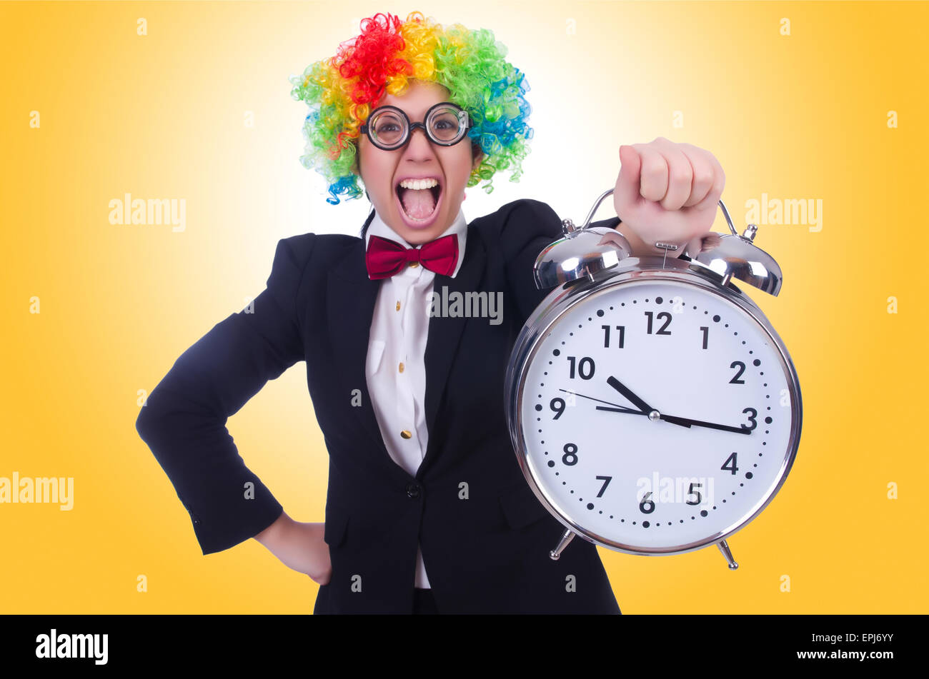 Funny clown with clock on white Stock Photo - Alamy