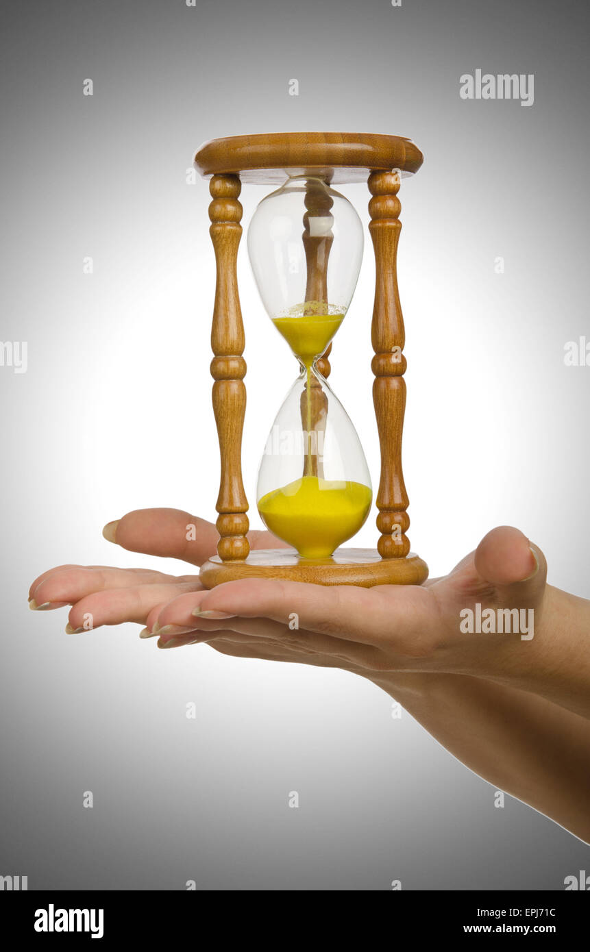 Hand holding hourglass on white Stock Photo - Alamy