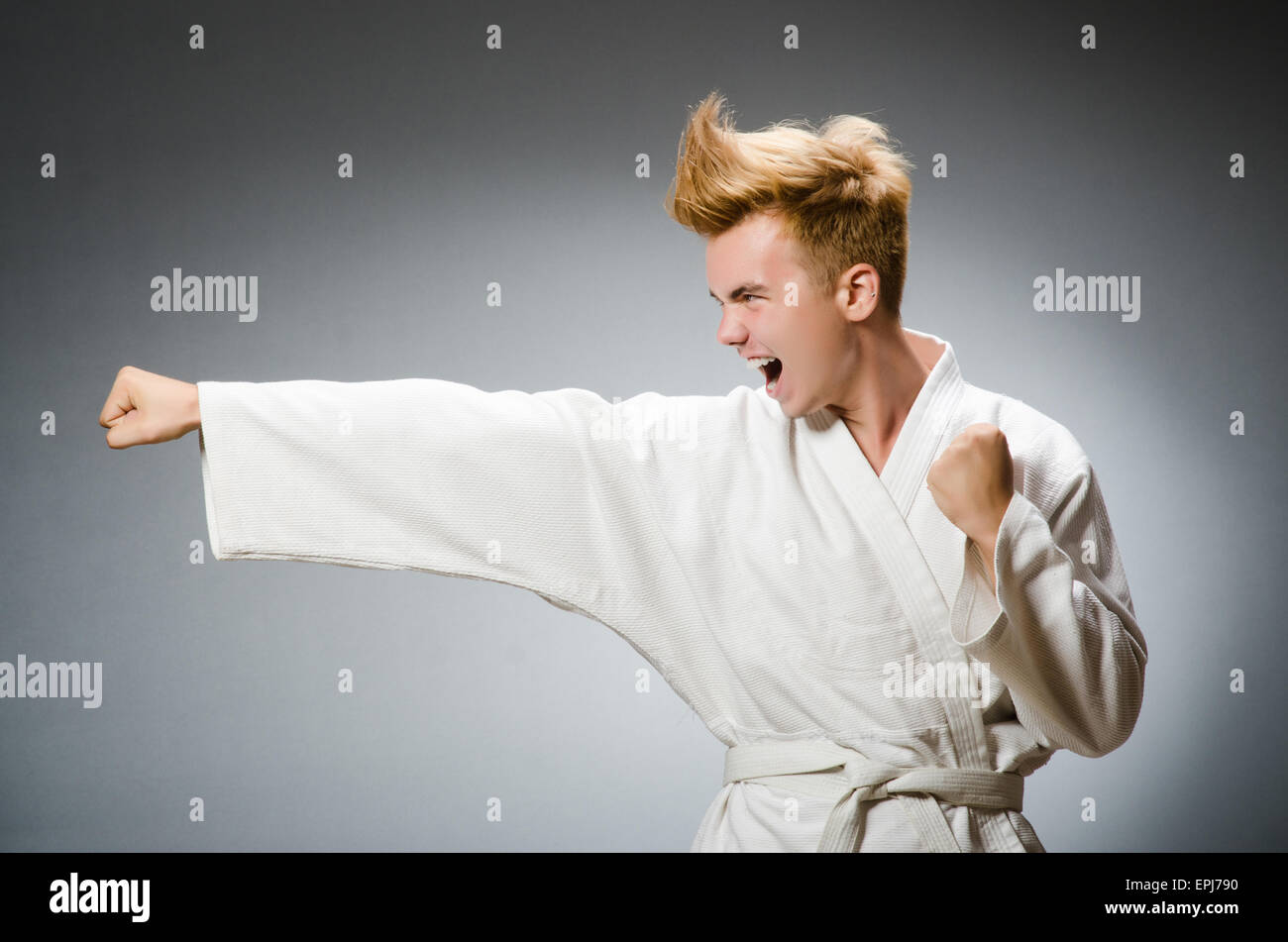 Funny karate fighter wearing white kimono Stock Photo - Alamy