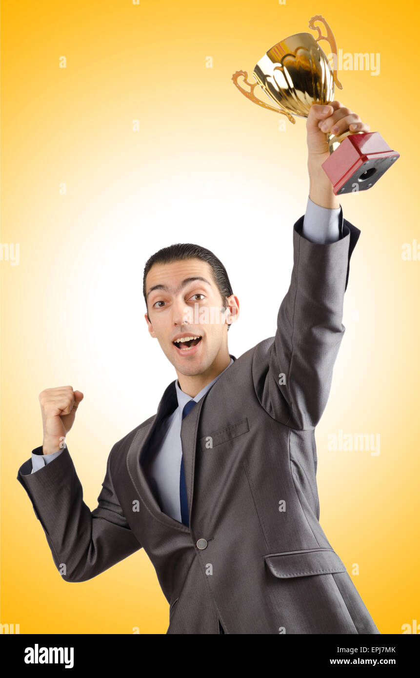 Man being awarded with golden cup Stock Photo - Alamy