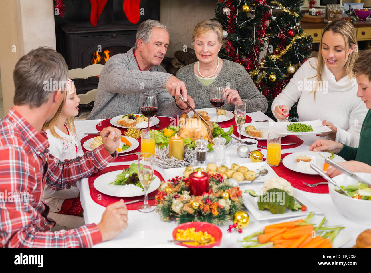 Three generation family having christmas dinner together Stock Photo ...