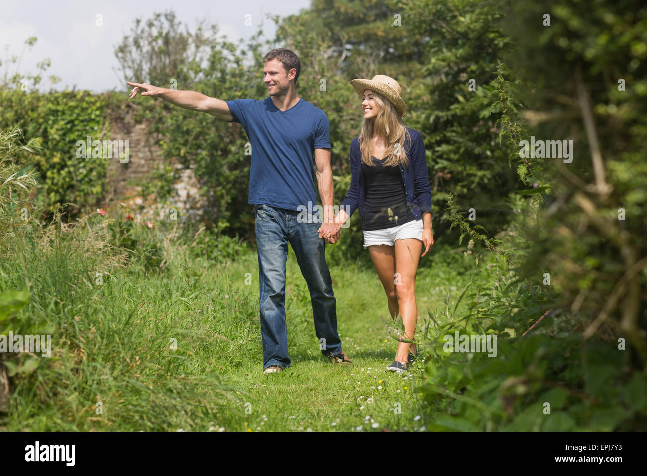 Cute couple walking holding hands Stock Photo - Alamy