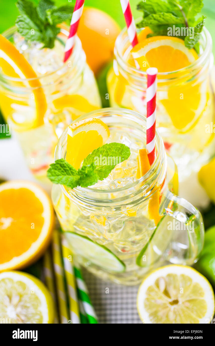 Infused water with fresh citrus fruits and ice Stock Photo - Alamy