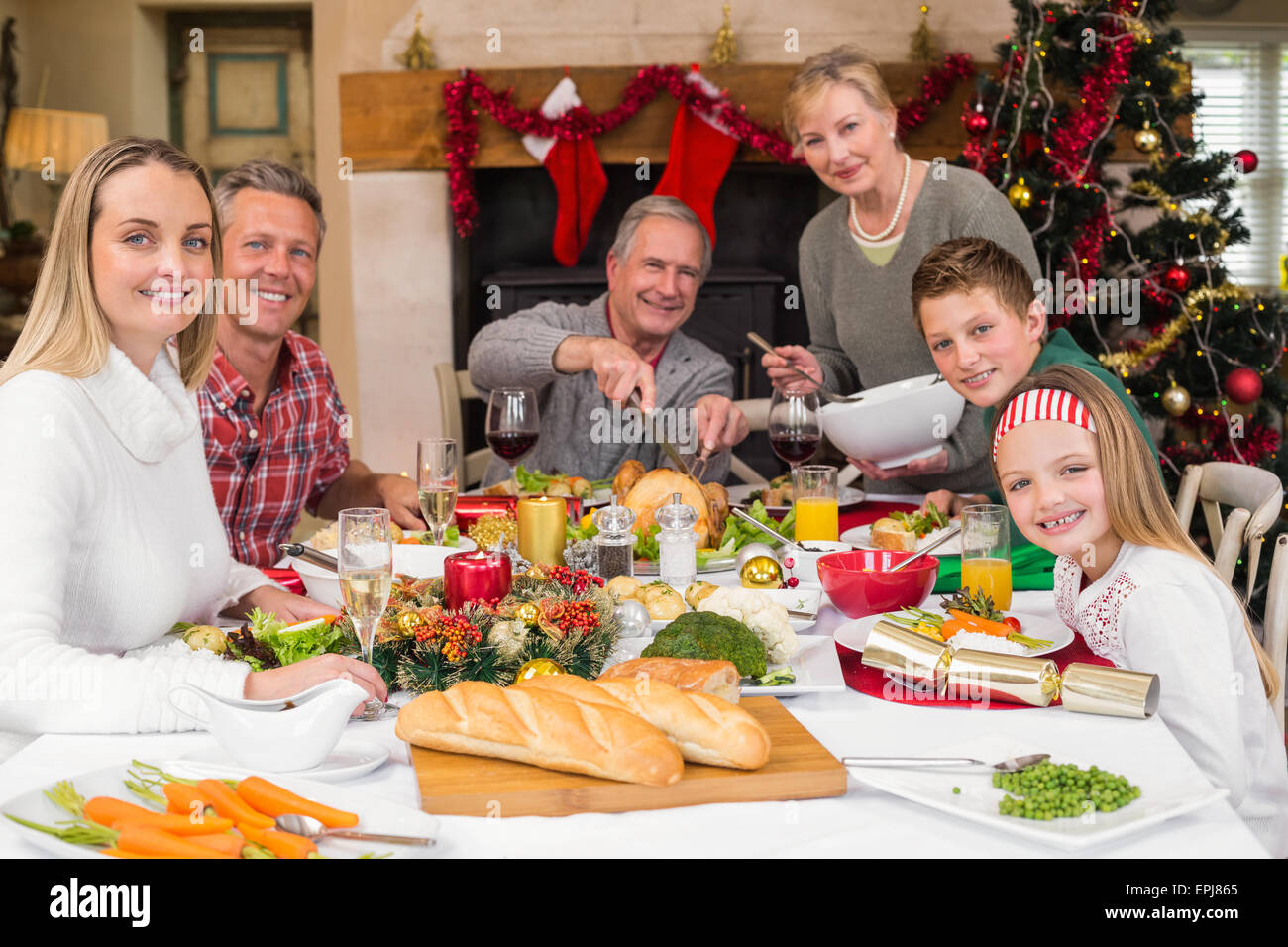 Grandfather carving chicken during christmas dinner Stock Photo - Alamy