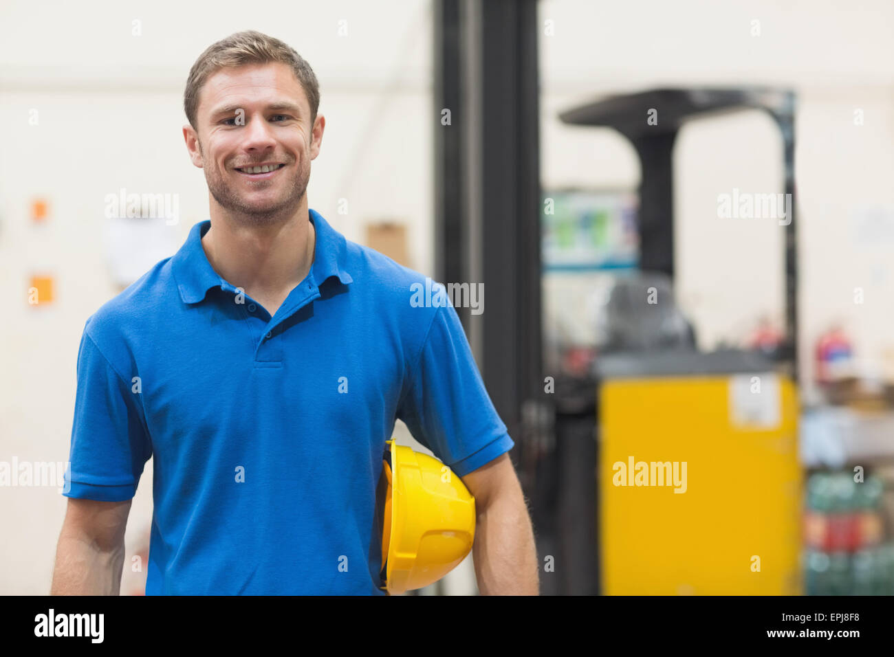 Handsome warehouse worker smiling at camera Stock Photo - Alamy