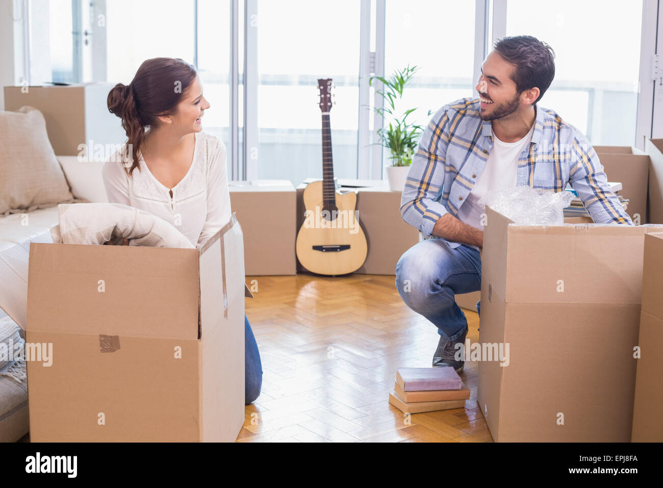 Cute couple unpacking cardboard boxes Stock Photo - Alamy
